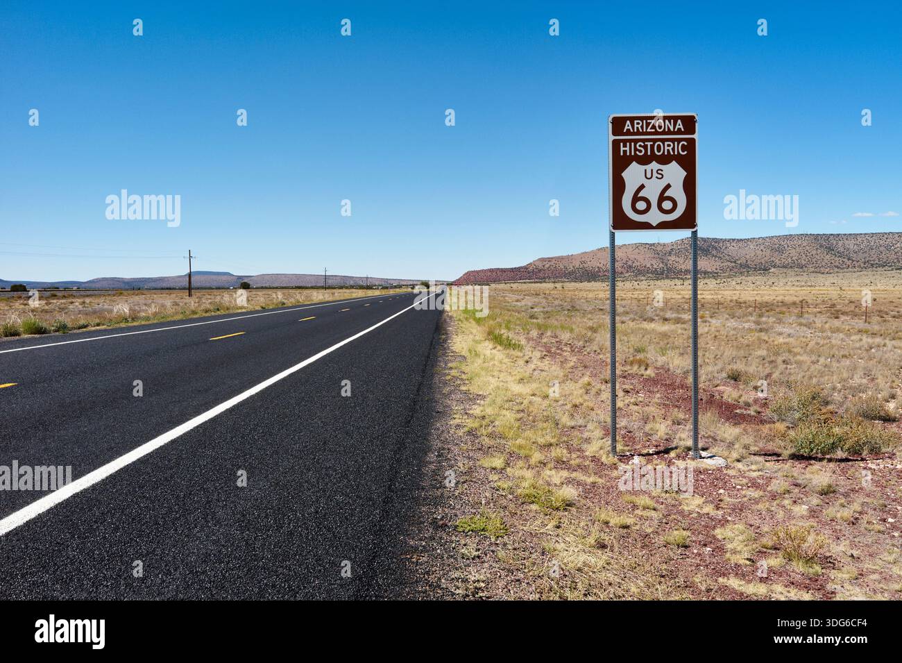 Open road under a clear sky with a historic Route 66 sign in Arizona ...