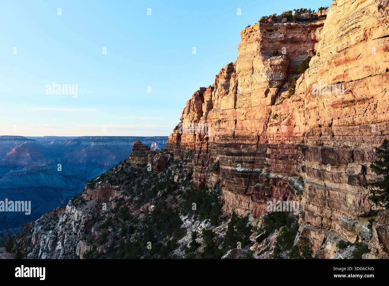 Majestic Grand Canyon cliffs bathed in warm morning light with clear ...