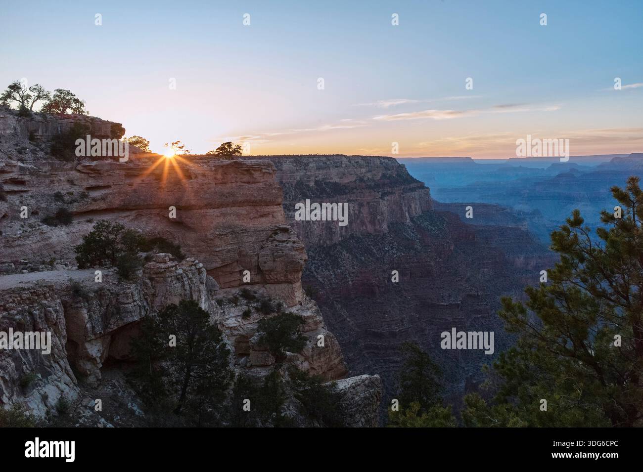 Sunrise over the Grand Canyon with a vivid sky and rugged cliffs in the ...