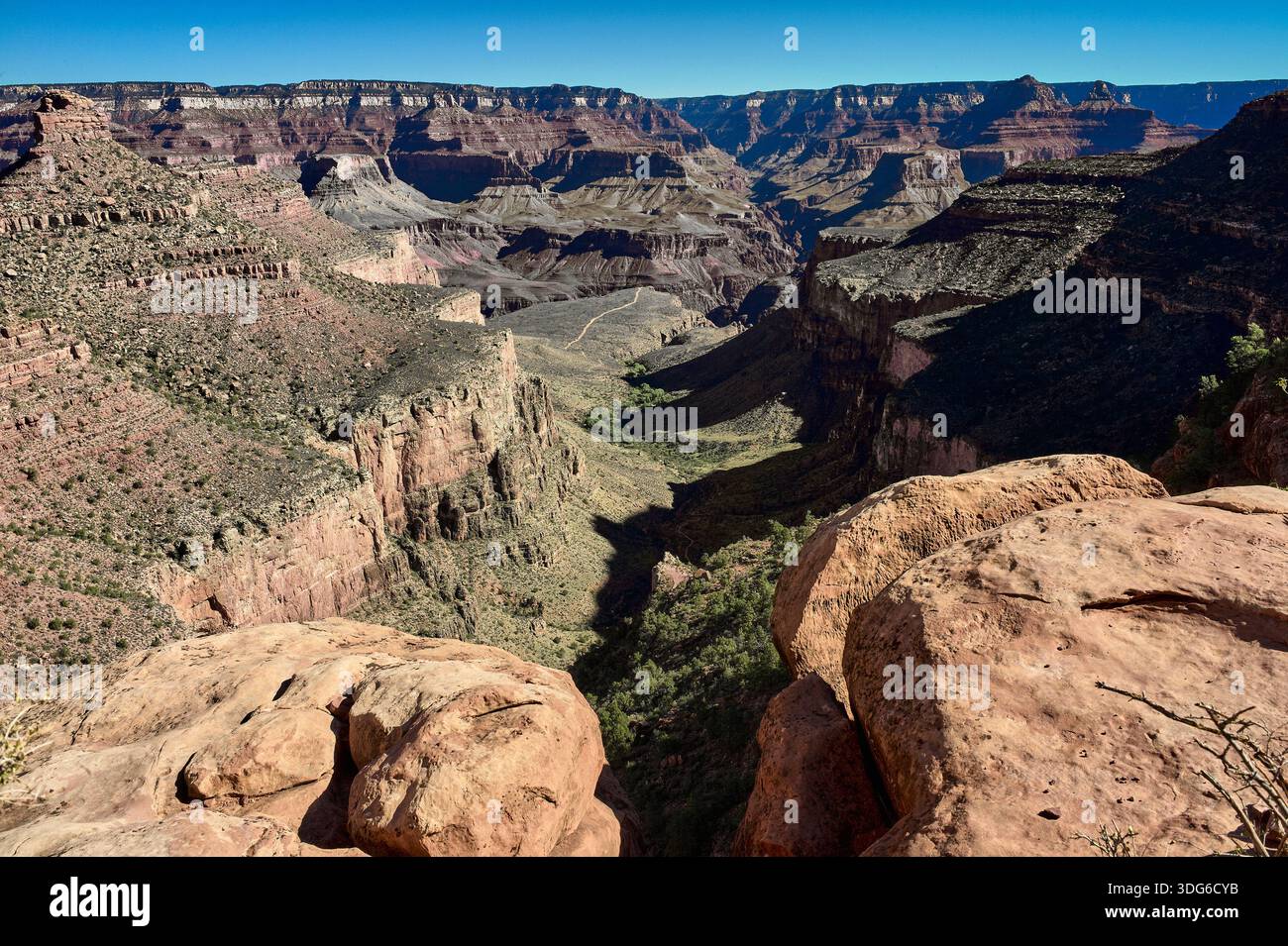 Majestic canyon landscape under a clear blue sky with rugged rock ...