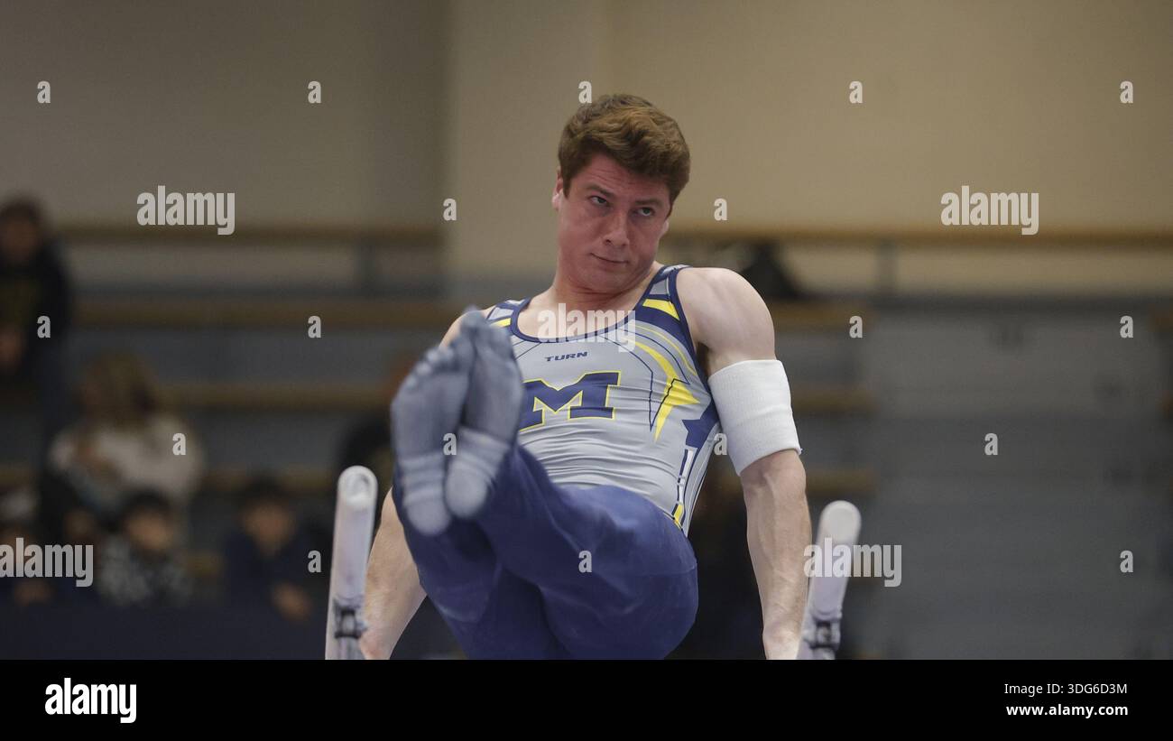 Michigan's Kyle Walchuk competes on the parallel bars during an NCAA ...