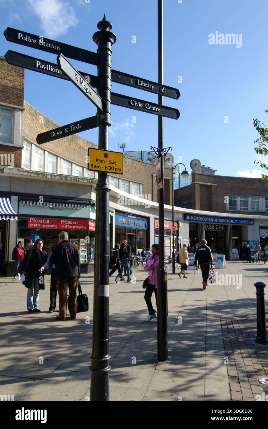 Uxbridge town centre near Tube station, signpost and shoppers ...