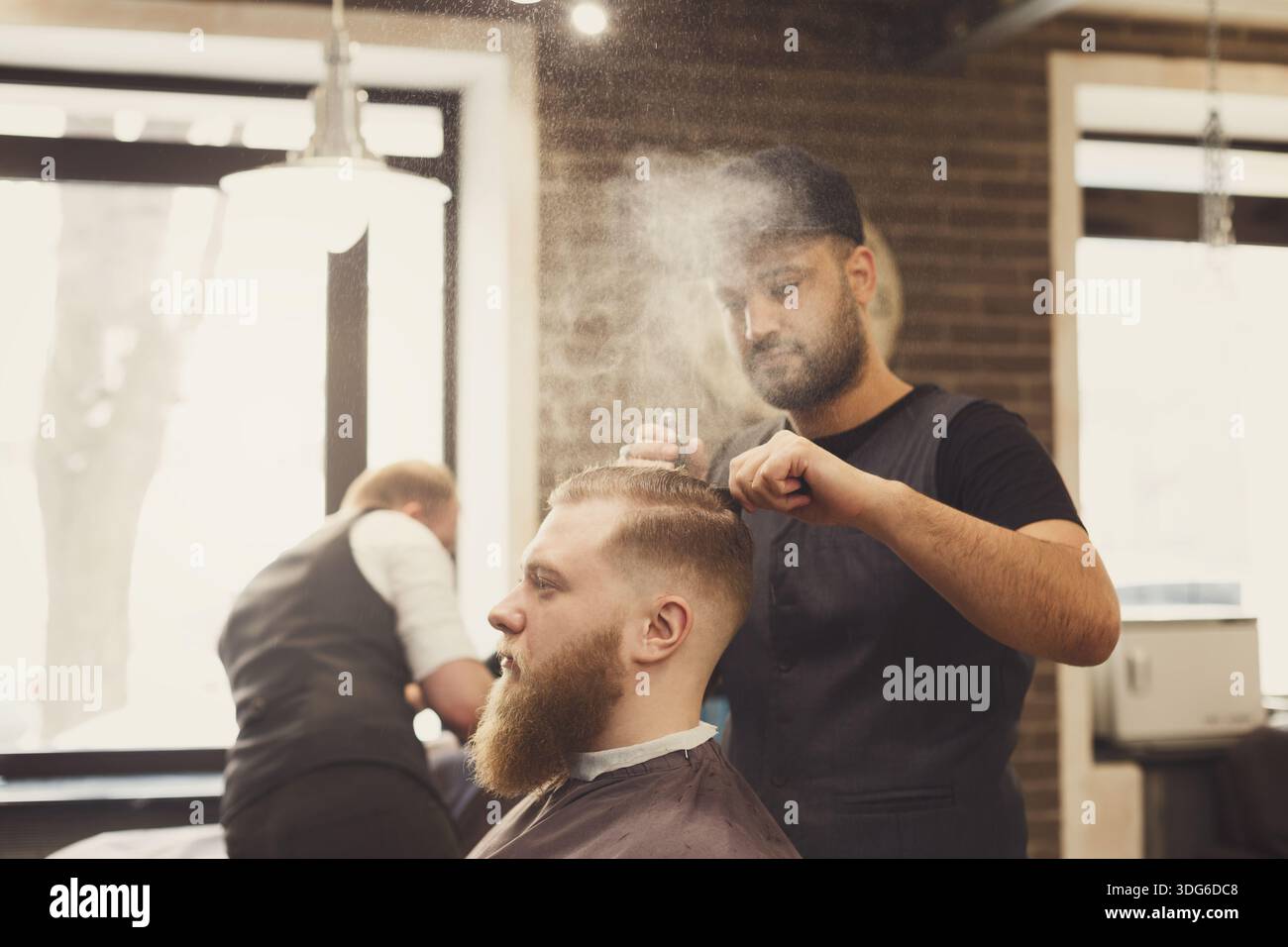 Man getting haircut by hairstylist at barbershop Stock Photo - Alamy