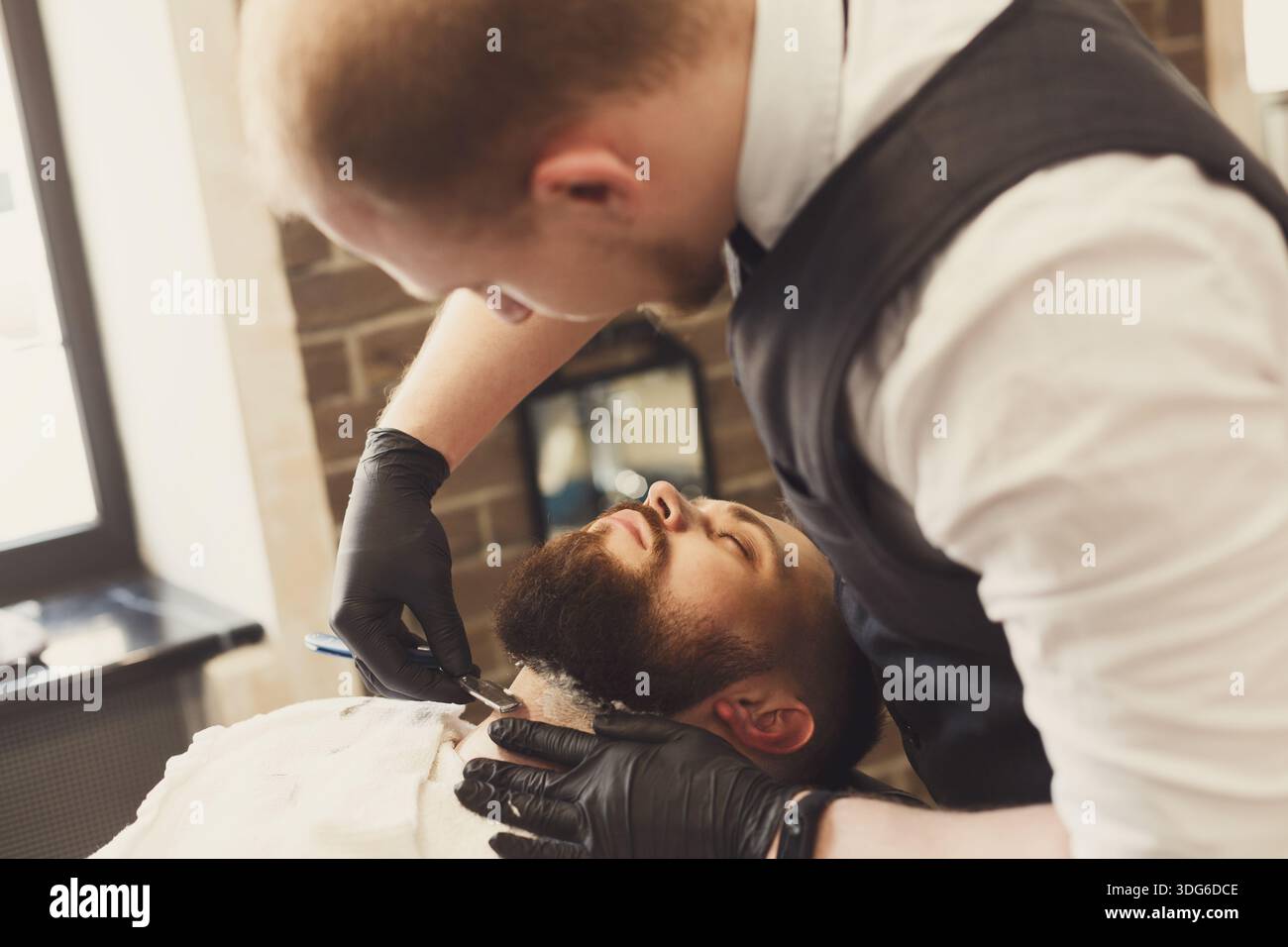 Man getting haircut by hairstylist at barbershop Stock Photo - Alamy