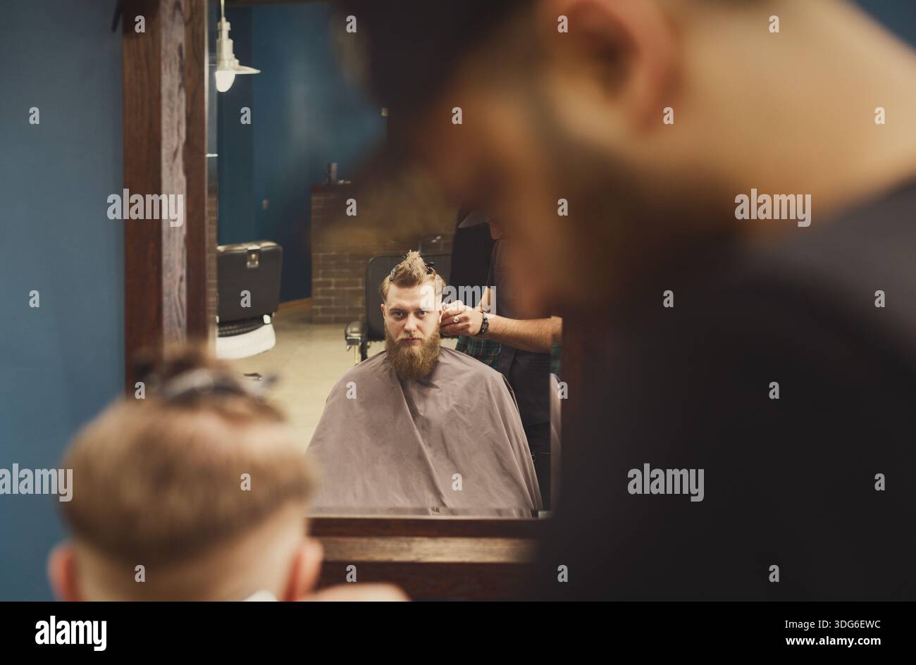 Man getting haircut by hairstylist at barbershop Stock Photo - Alamy