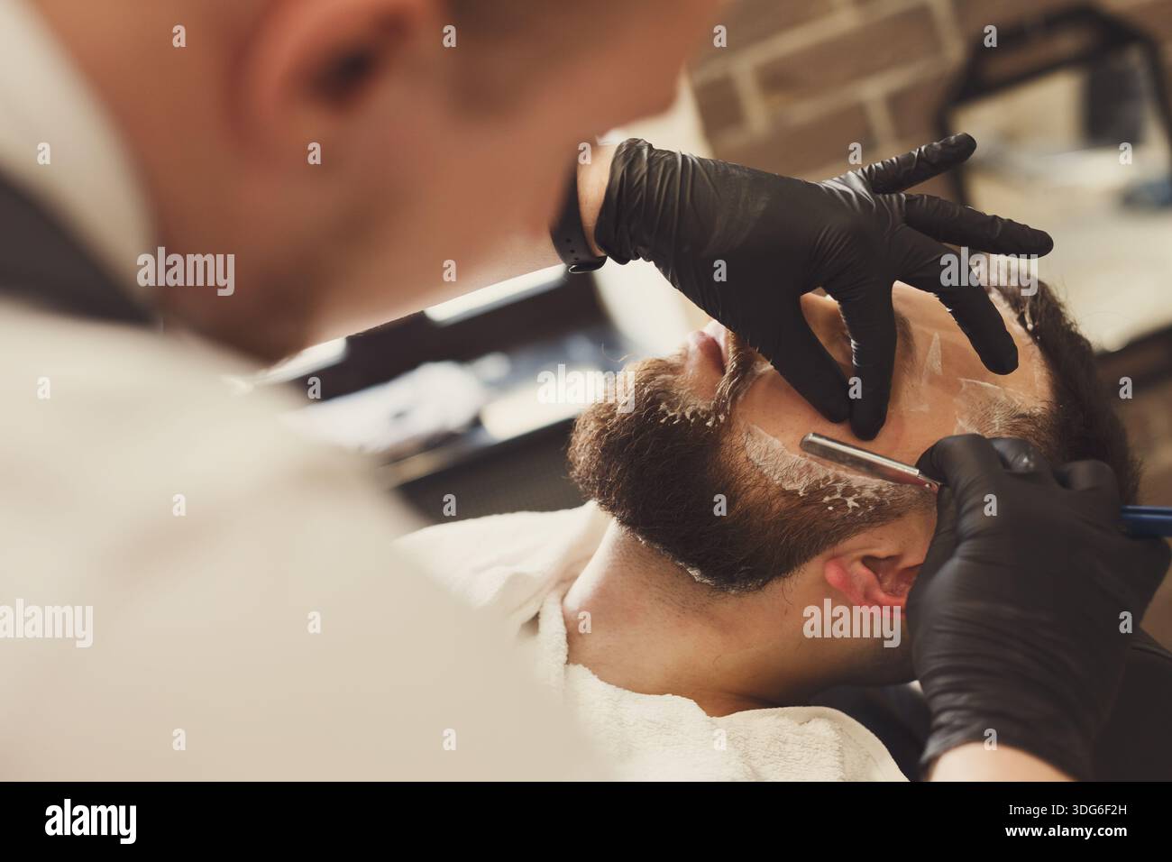 Man getting haircut by hairstylist at barbershop Stock Photo - Alamy