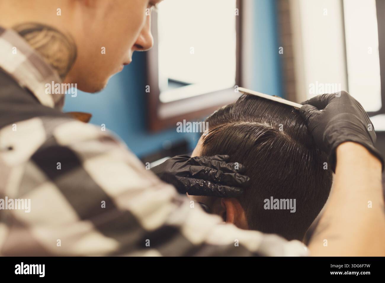 Man getting haircut by hairstylist at barbershop Stock Photo - Alamy