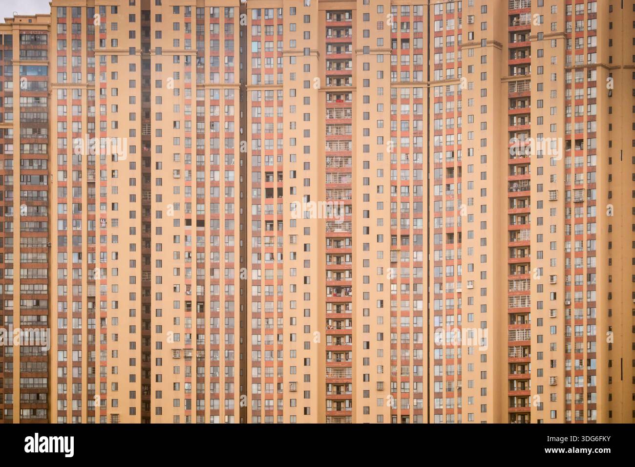 Tall residential buildings with uniform rows of windows and balconies ...