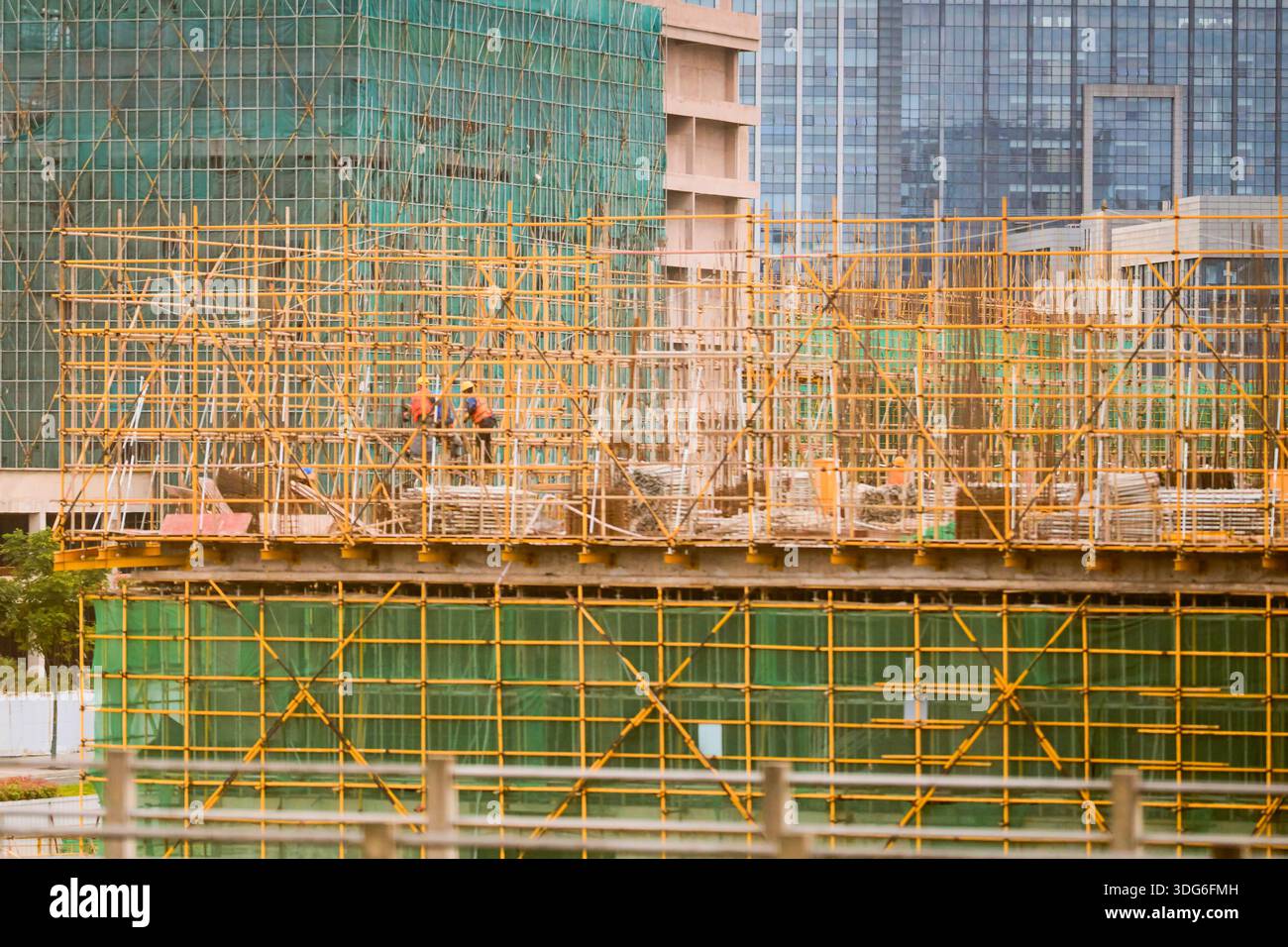 Construction site with scaffolding and workers building a multi-story ...