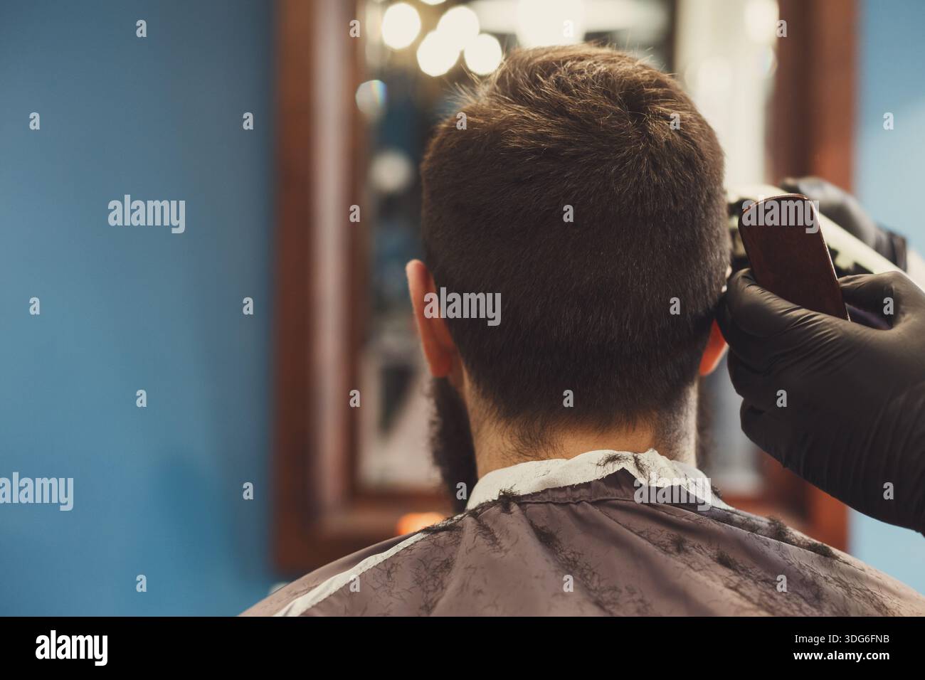Man getting haircut by hairstylist at barbershop Stock Photo - Alamy