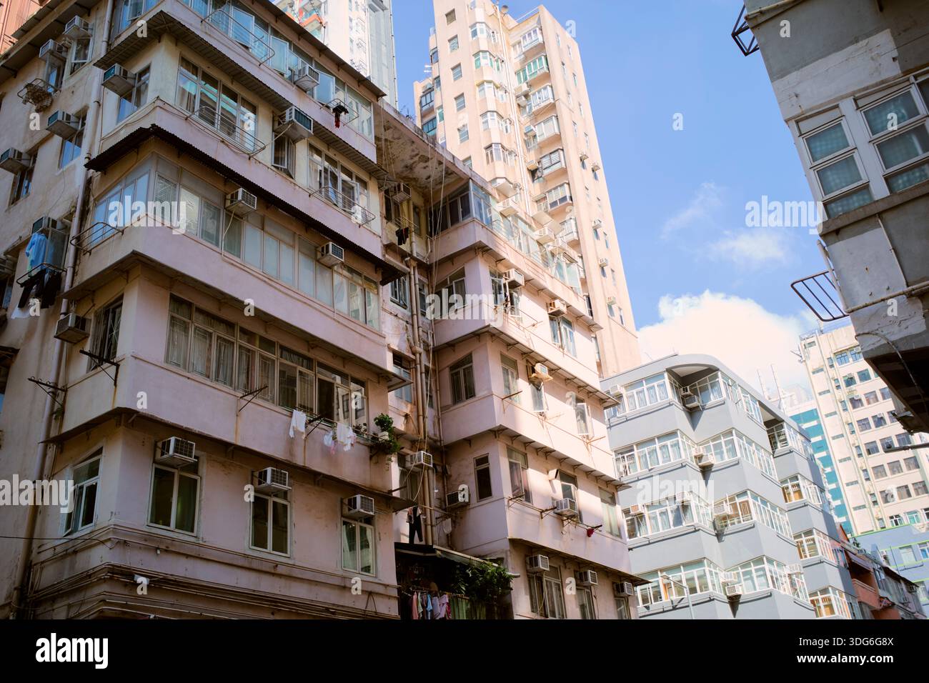 Cluster of urban residential buildings under a clear blue sky in a ...