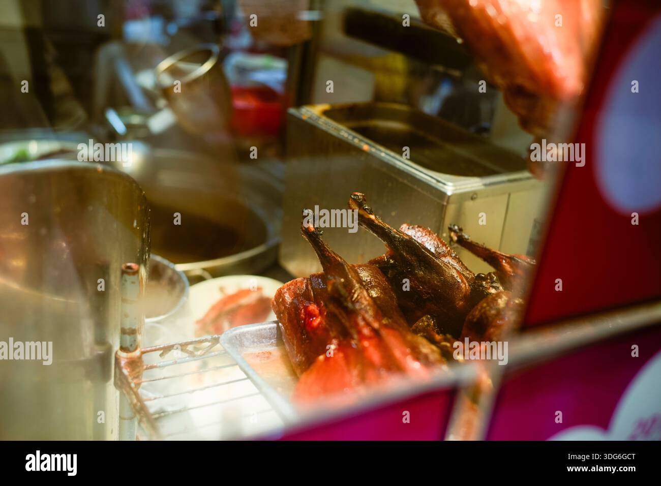 Roasted duck display in a restaurant window with stainless steel ...