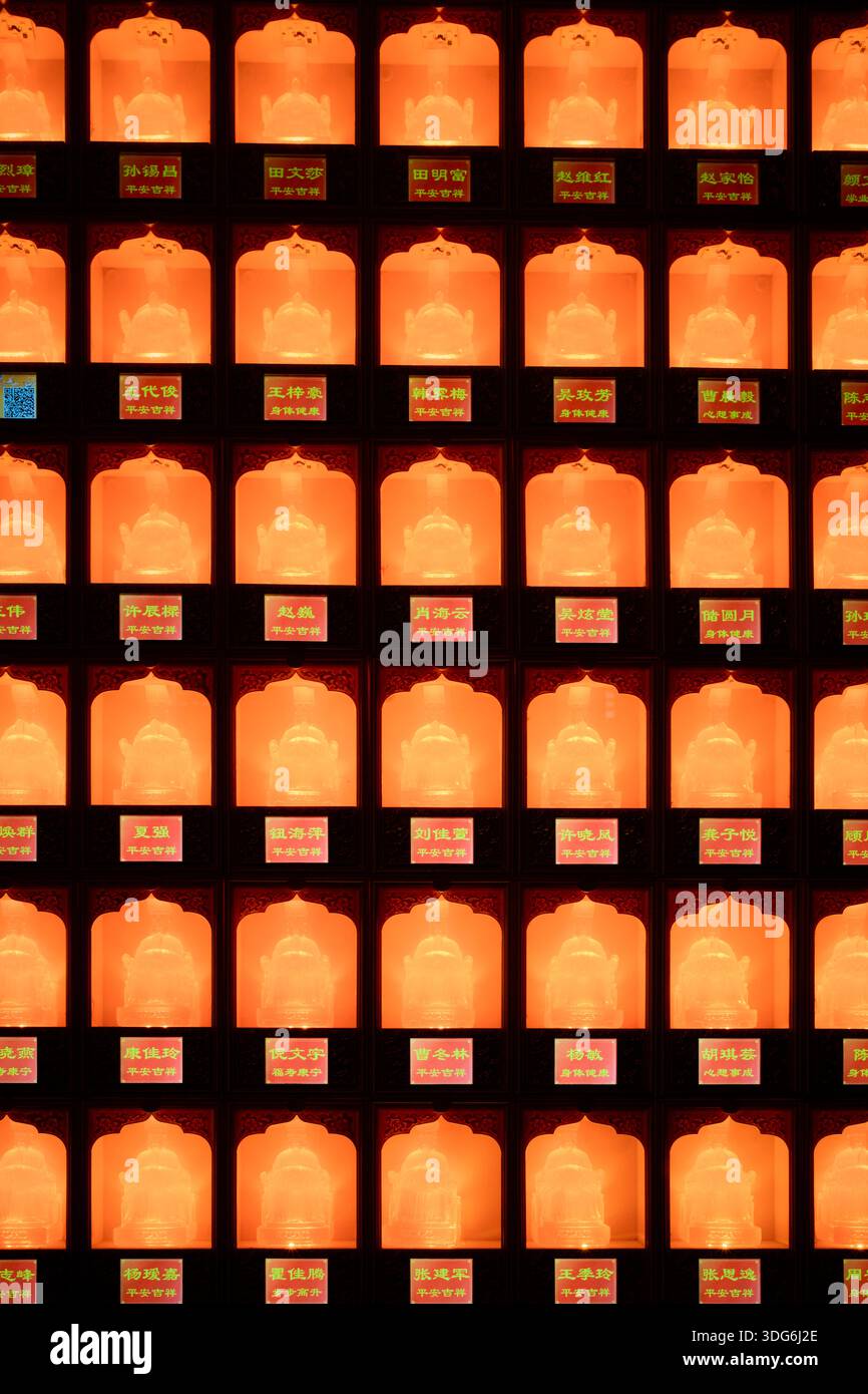 Rows of illuminated orange lanterns with intricate designs and text in ...
