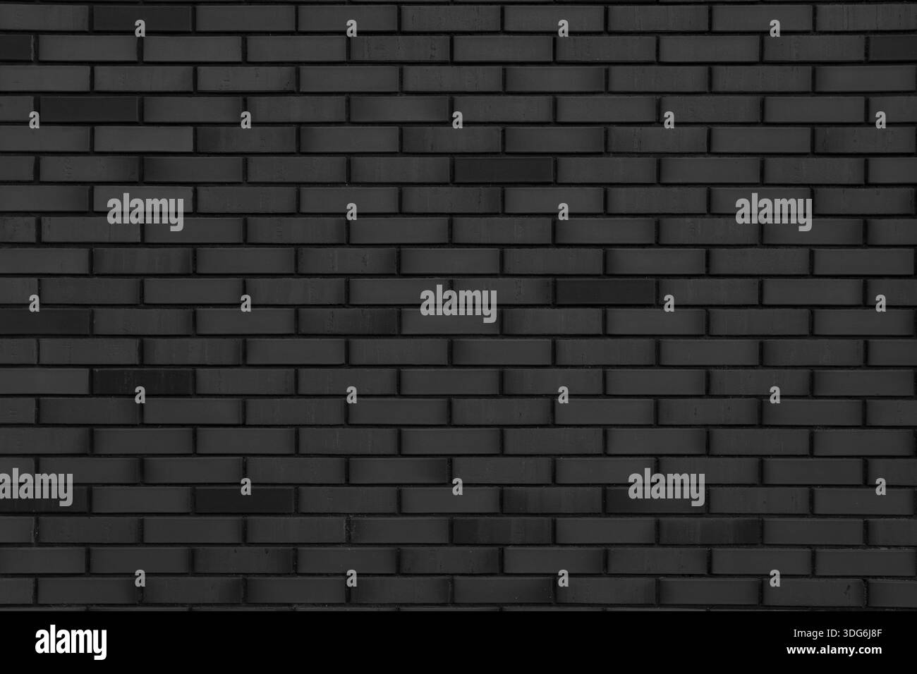 Brick wall made of black rectangular bricks with dark gray mortar. The ...
