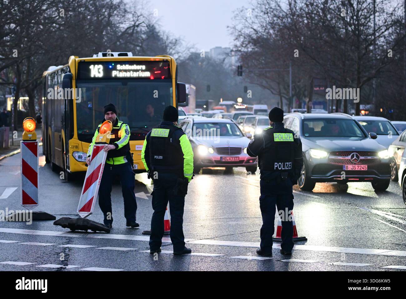 15 January 2026, Berlin: Police officers close a road near the Funkturm ...