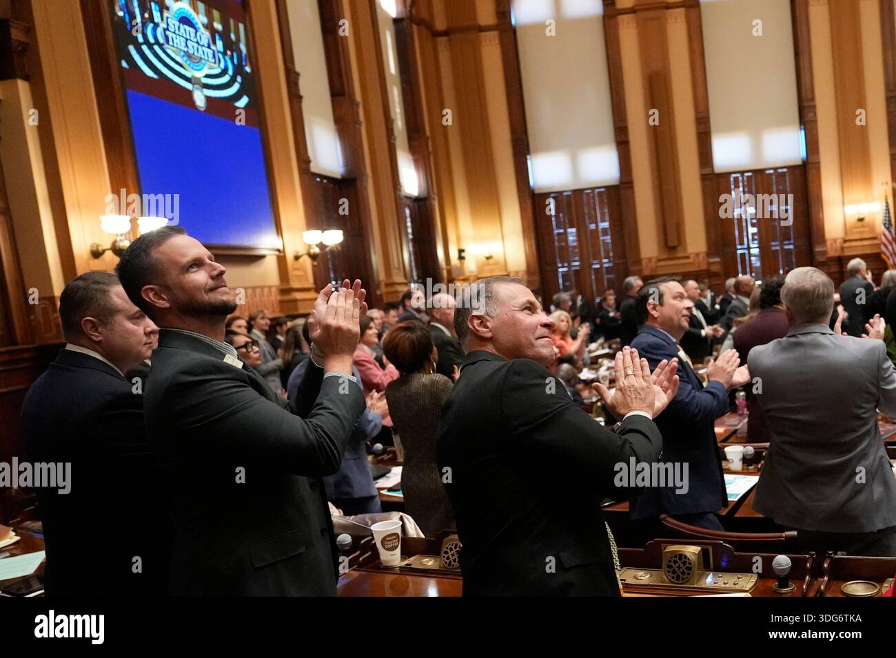 Legislators applaud as Gov. Brian Kemp delivers the State of the State ...