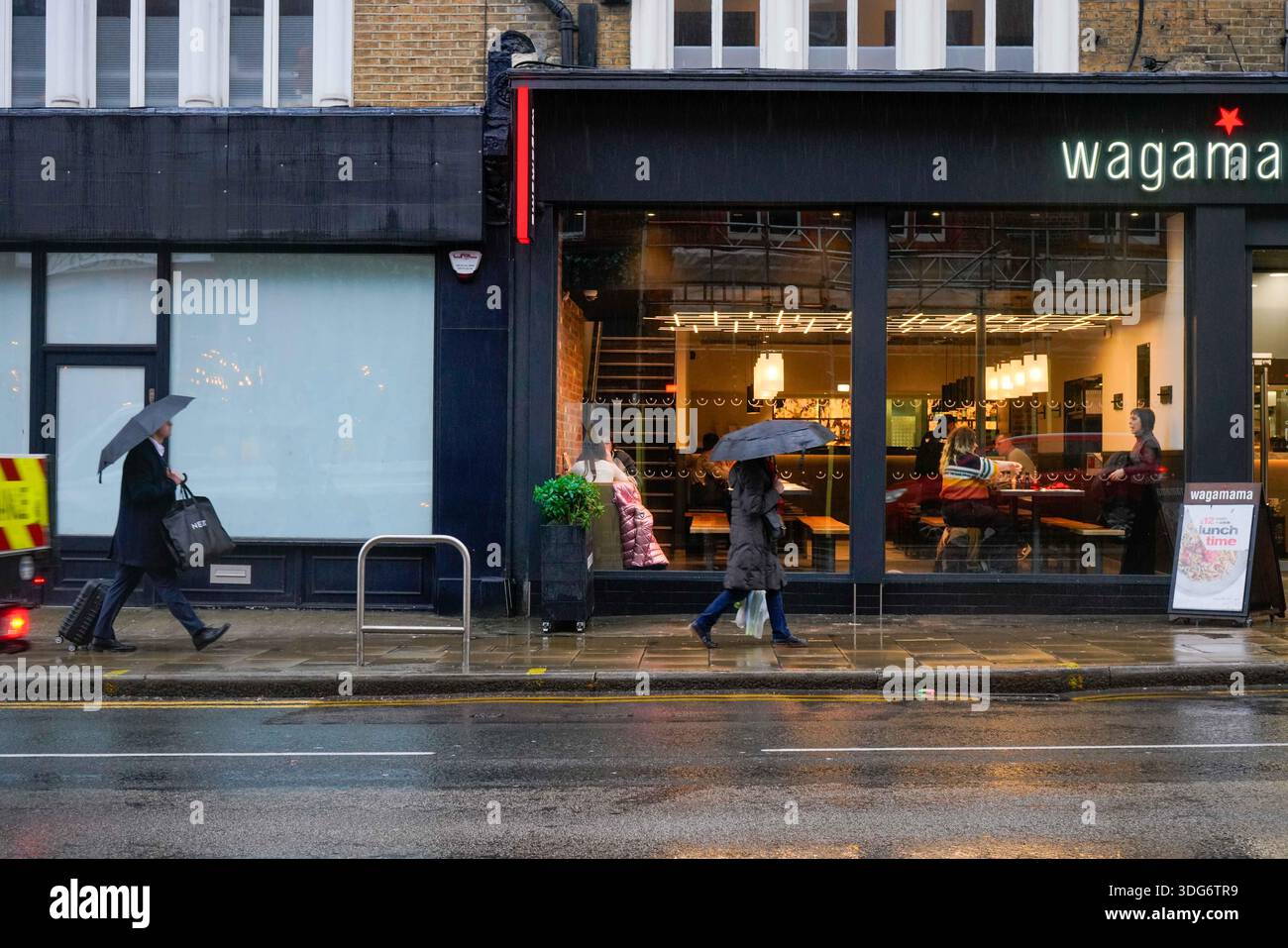 Wimbledon, South West London. 16th January 2026. Commuters shield ...