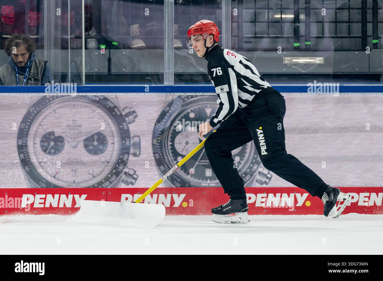 Linesperson Kenneth Englisch lends a hand with ice maintenance during a ...
