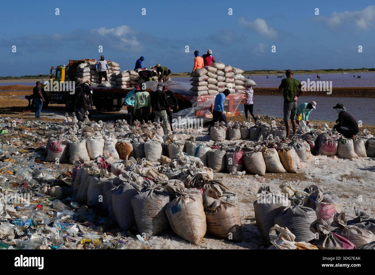 People work at the Salinas de Cumaraguas salt flats on the Paranguana ...