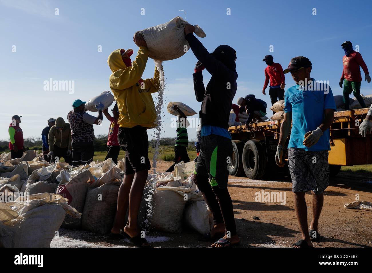 People work at the Salinas de Cumaraguas salt flats on the Paranguana ...