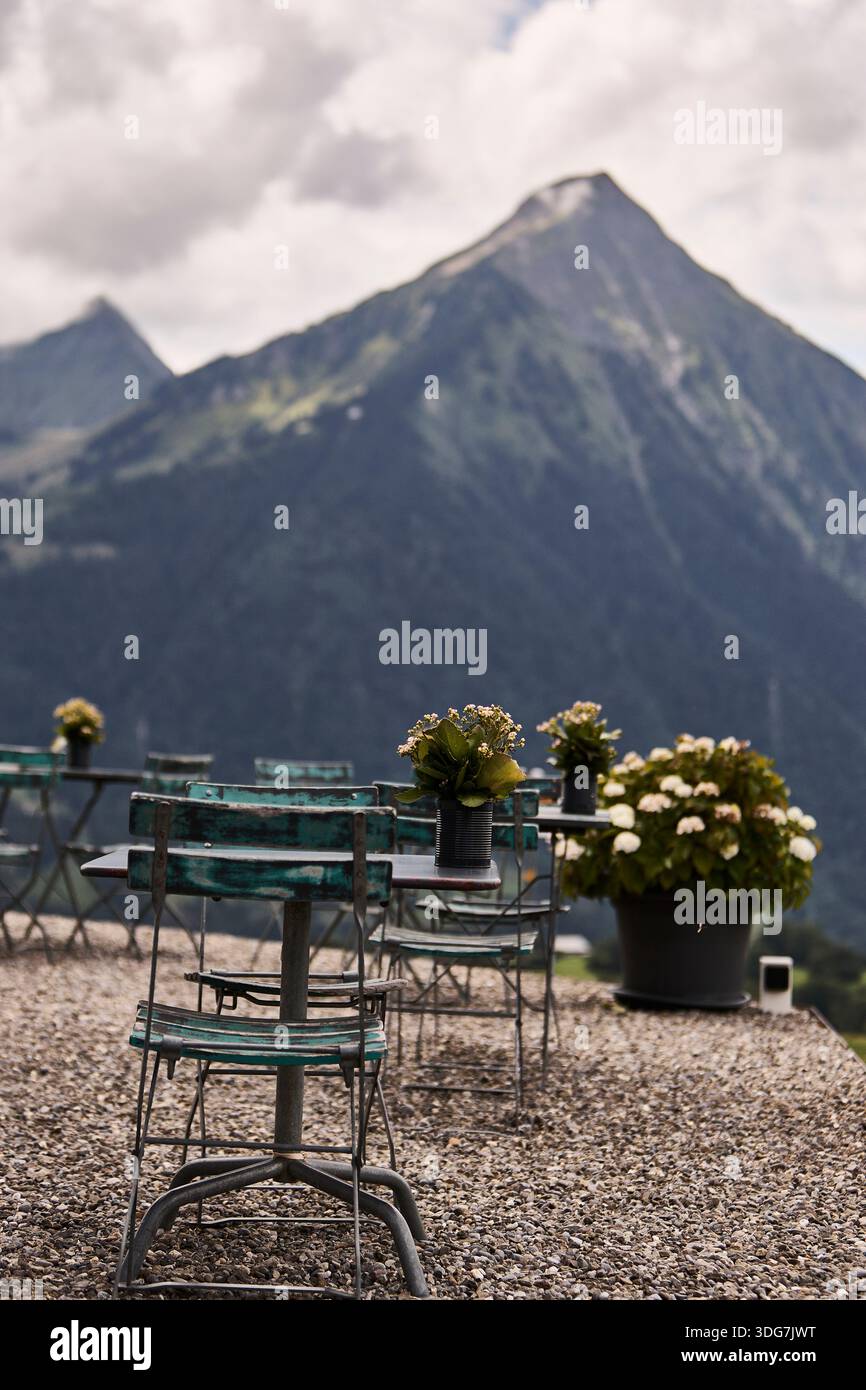 Outdoor Tables and Chairs Near a Swiss Hotel with Alpine View in Summer ...