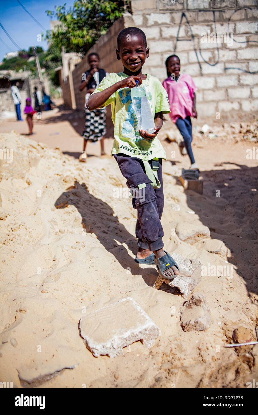An African child in motion in the foreground during the Christmas ...