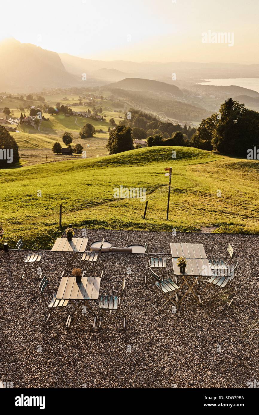 Outdoor Tables and Chairs Near a Swiss Hotel with Alpine View in Summer ...