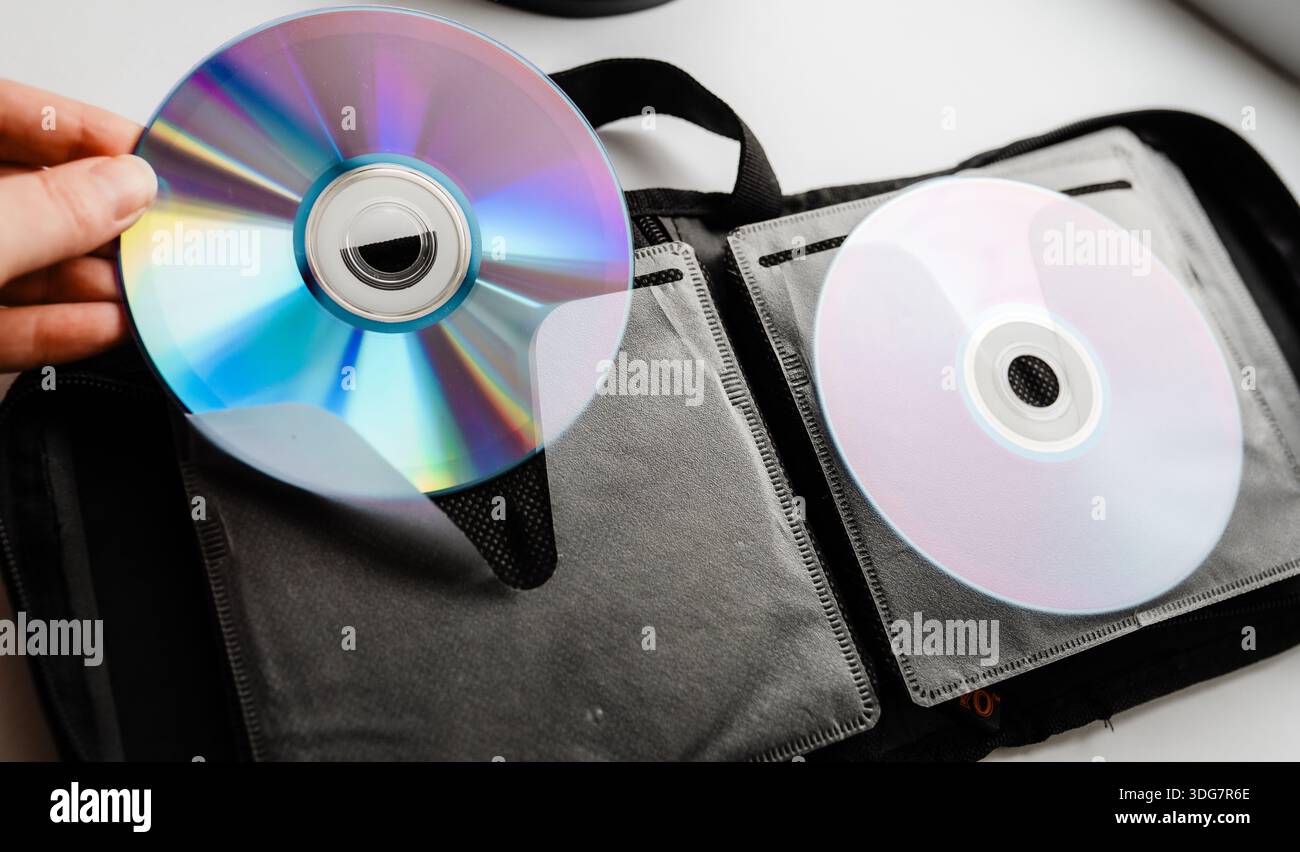 Bunch of CD and DVD discs organized in a disc holder Stock Photo - Alamy