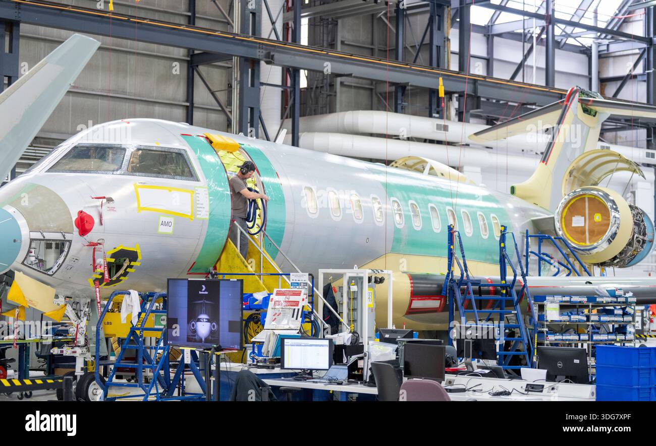 A Bombardier employee works on a Challenger jet at their manufacturing ...