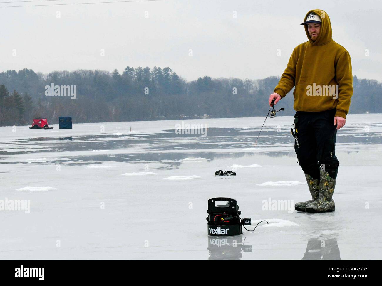 Justin Wheeler of Chester, Vt., jigs for a fish on the setbacks of the ...