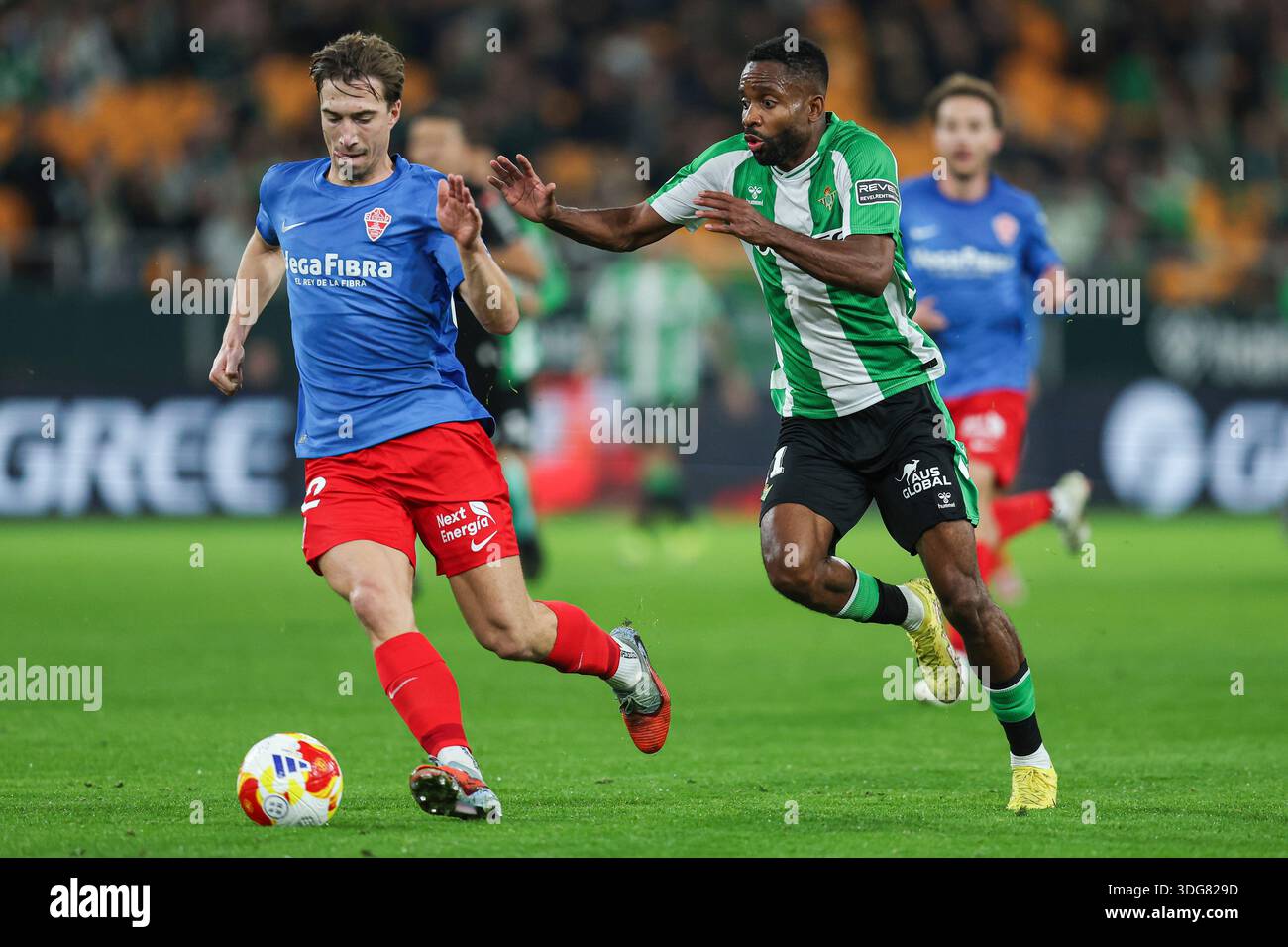 David Affengruber of Elche CF and Cedric Bakambu of Real Betis during ...