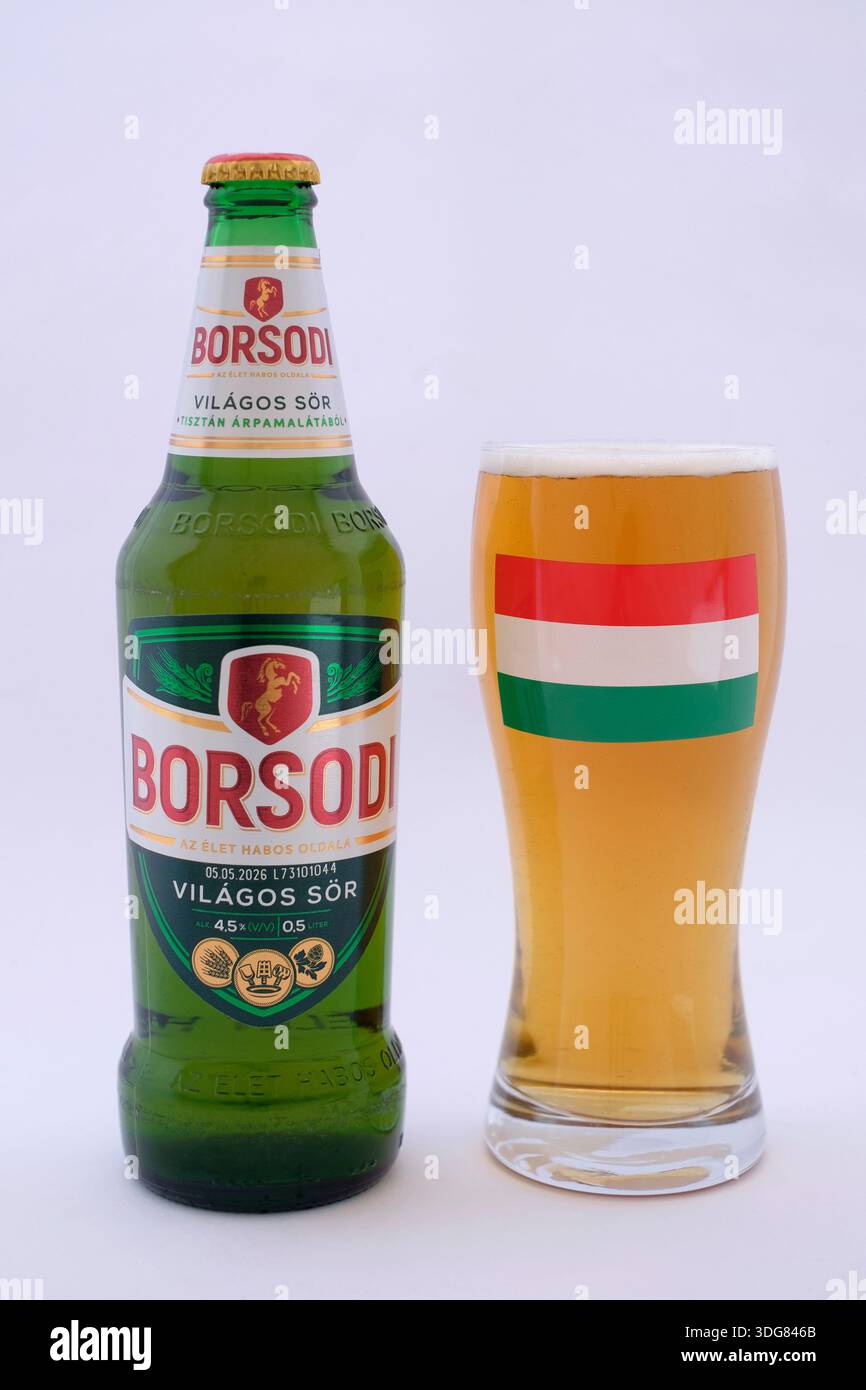 full beer glass with hungarian tricolour flag logo next to bottle of ...