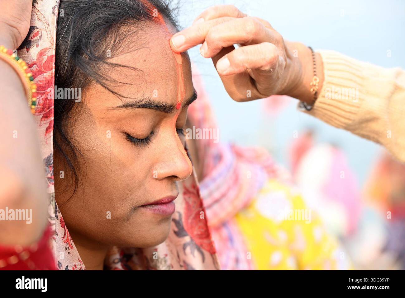 PATNA, INDIA - JANUARY 15: Devotees applying vermillion to each others ...