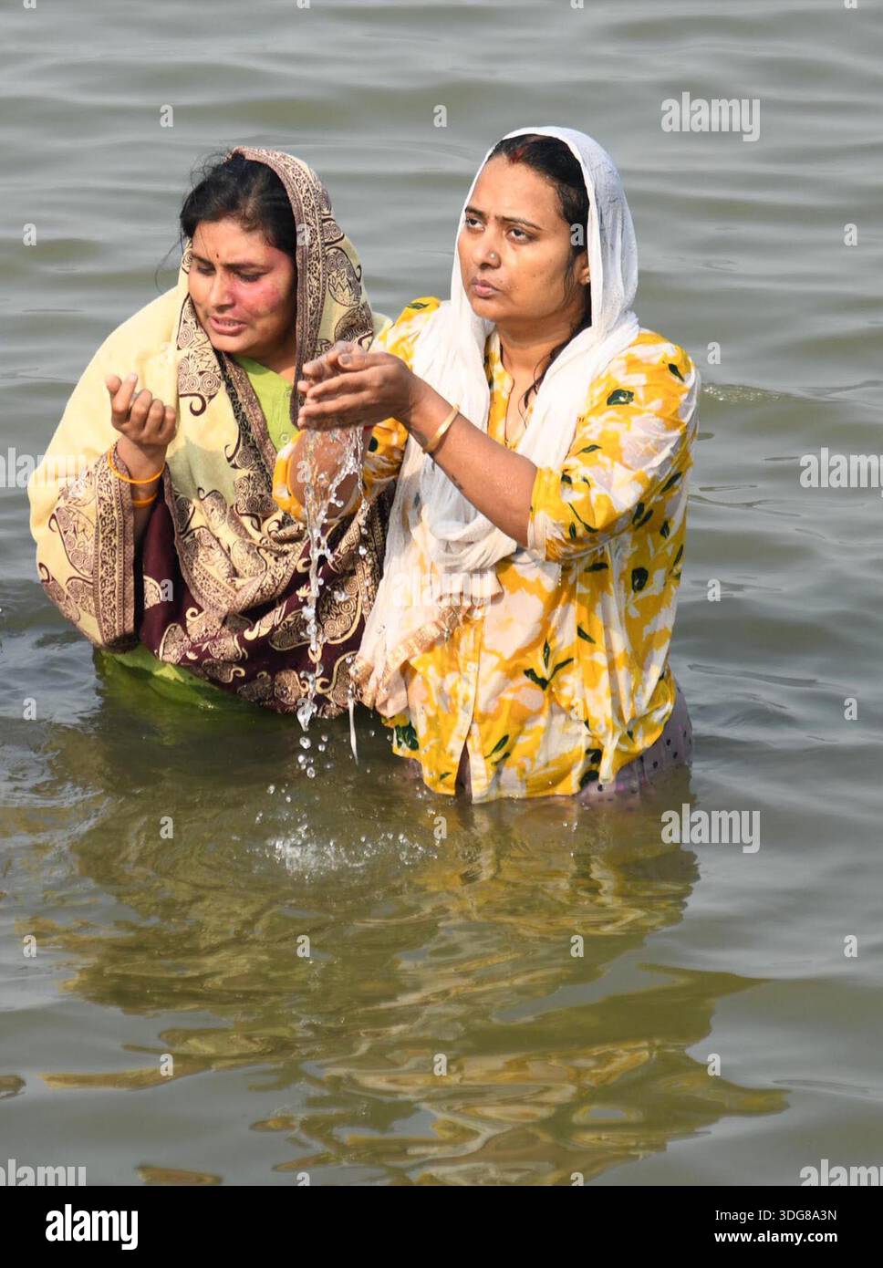 PATNA, INDIA - JANUARY 15: Devotees worshiping in the Ganga river on ...