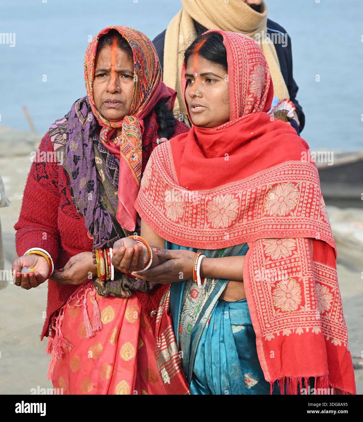 PATNA, INDIA - JANUARY 15: Devotees worshiping at the bank of Ganga ...