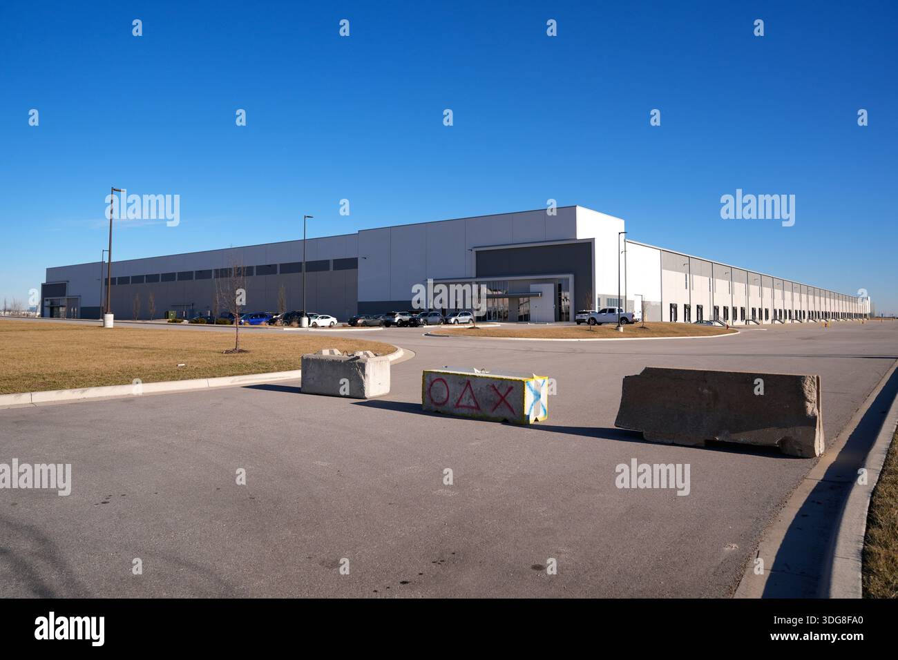 Barricades block a drive outside a warehouse as federal officials tour ...