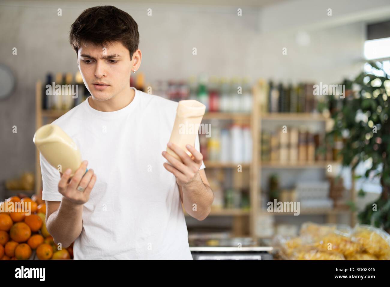 Guy reading labels bottles hi-res stock photography and images - Alamy