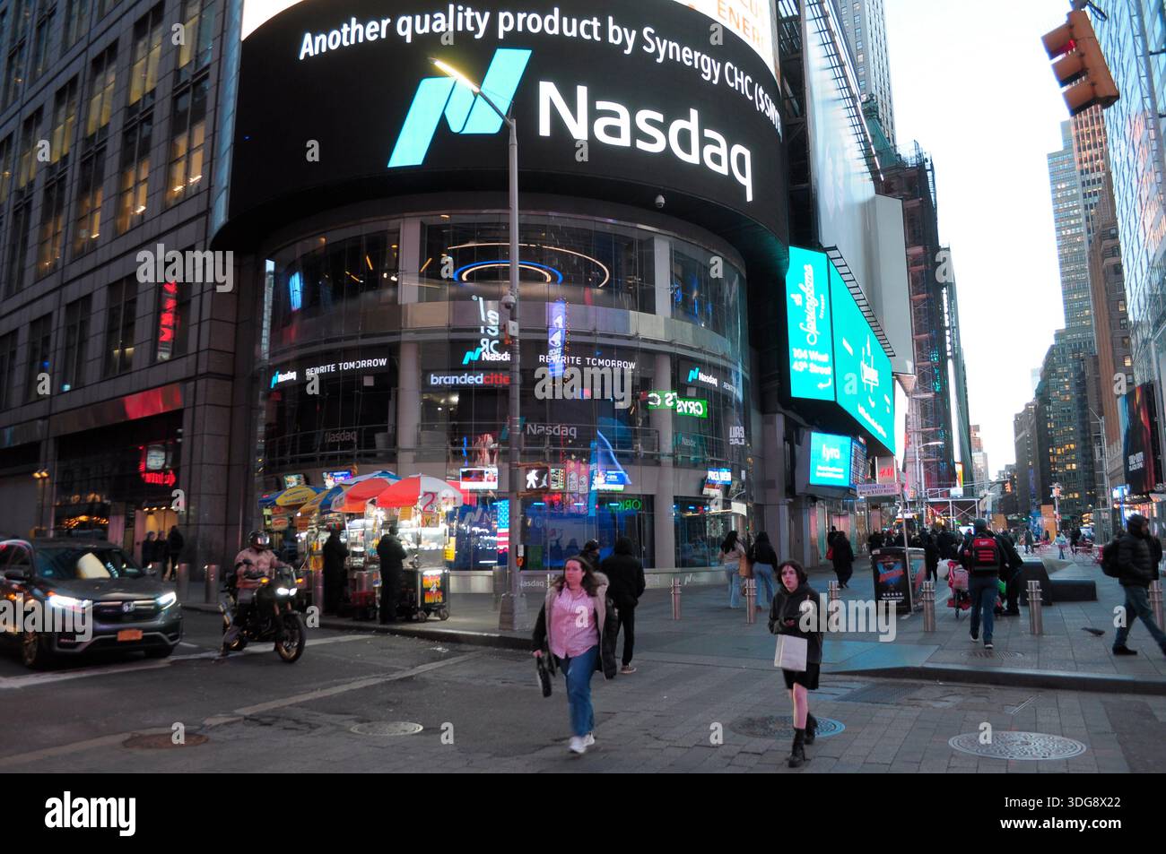 People walk past the Nasdaq MarketSite Times Square event space in ...