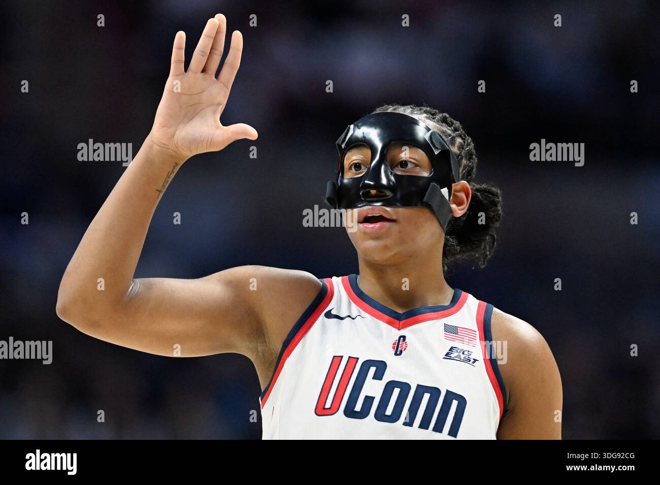 UConn guard KK Arnold gestures to her team in the first half of an NCAA ...