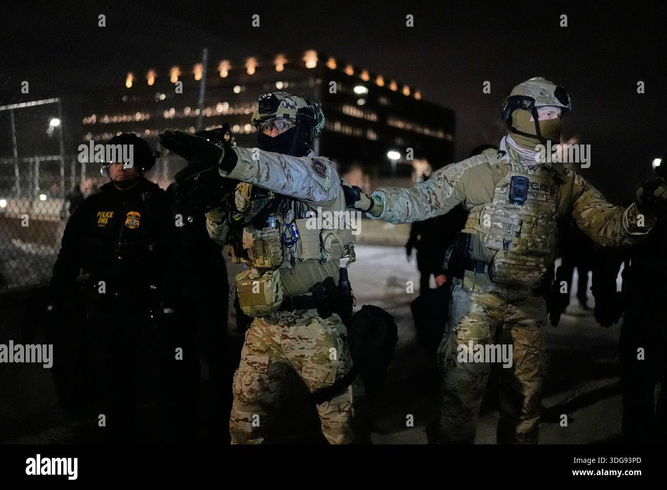 Federal immigration officers confront protesters outside Bishop Henry ...