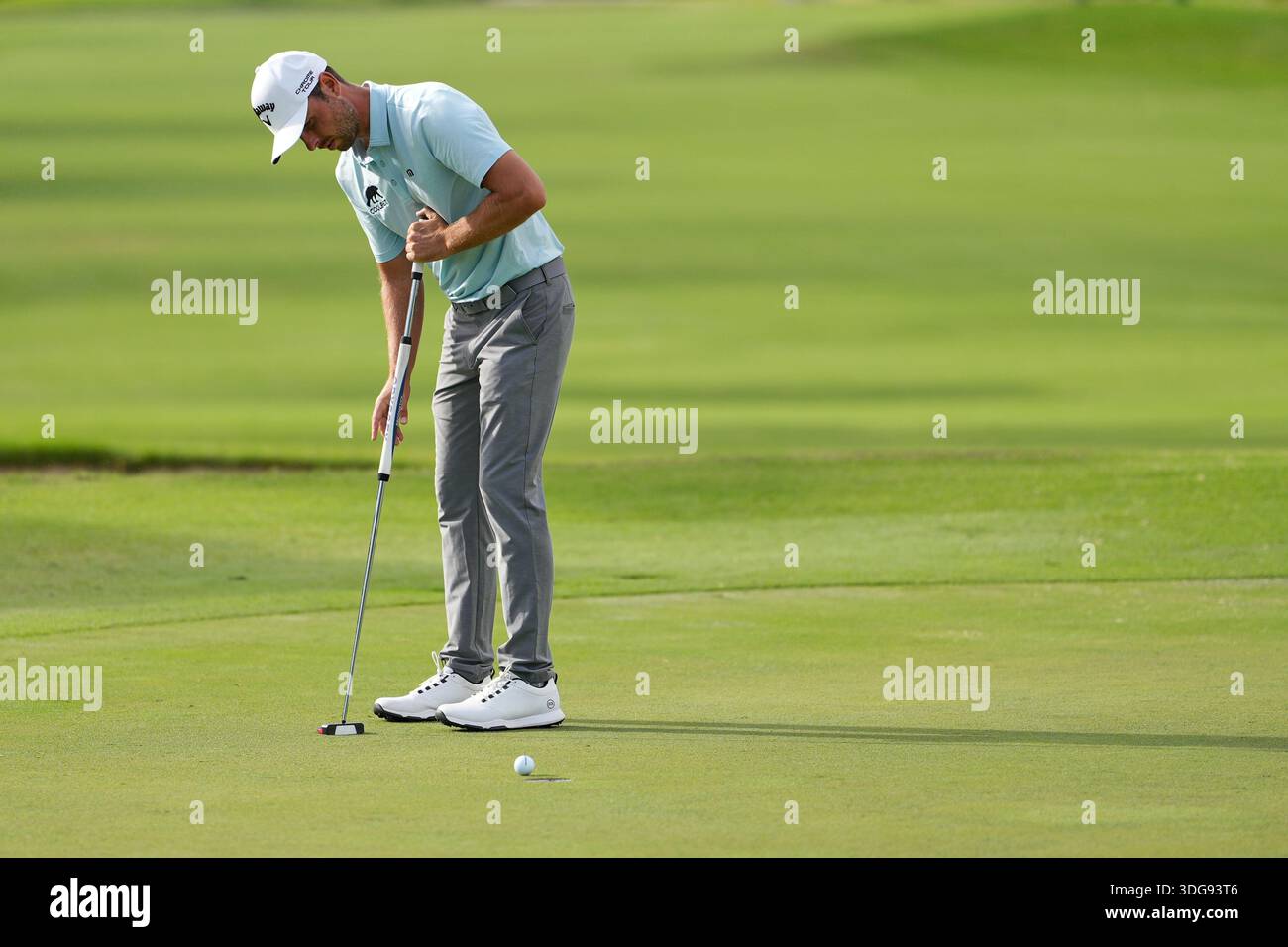 Adam Svensson, of Canada, putts during the first round of the Sony Open ...