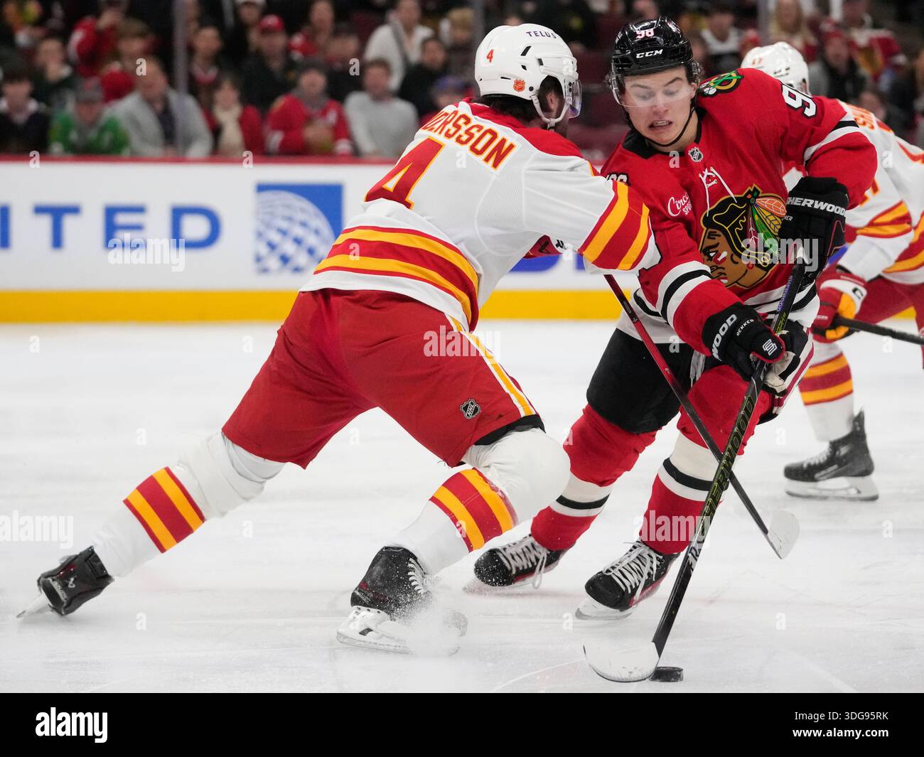 Calgary Flames defenseman Rasmus Andersson (4), left, checks Chicago ...