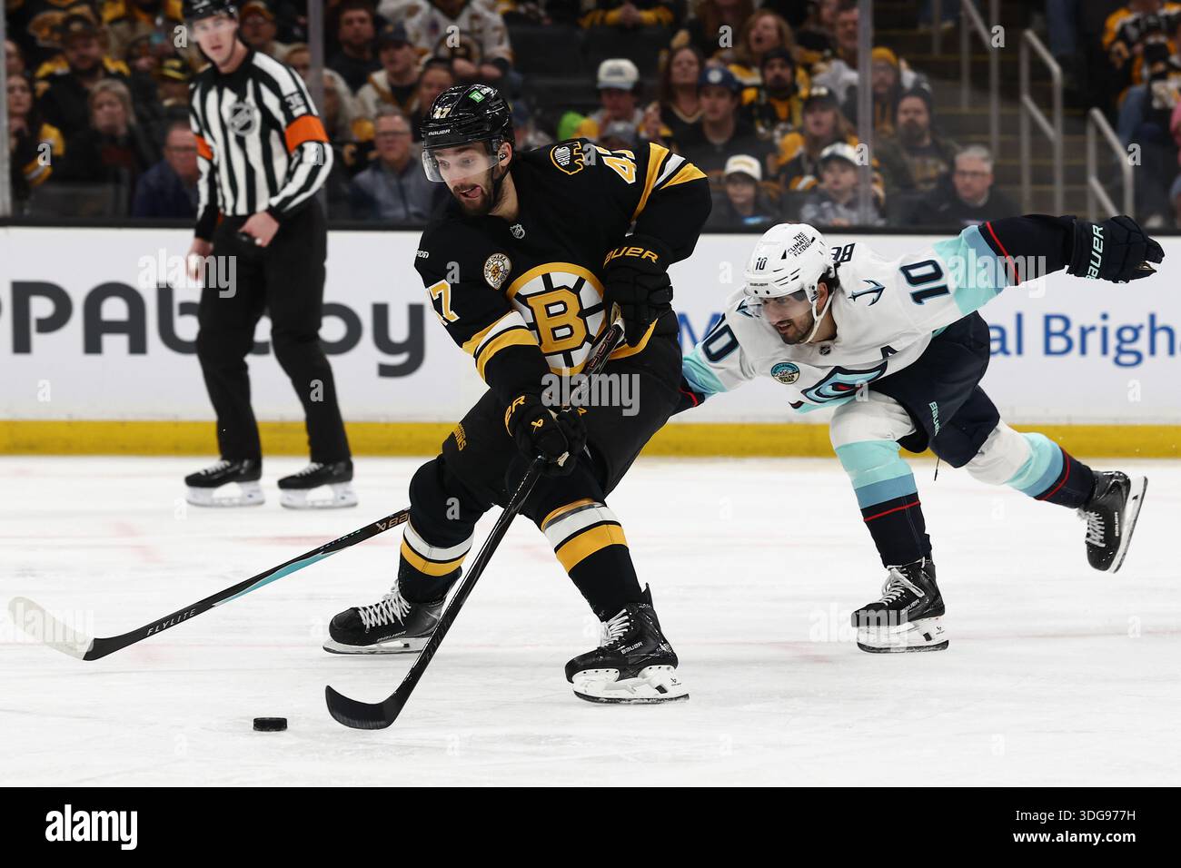 Boston Bruins' Mark Kastelic controls the puck after going past Seattle ...