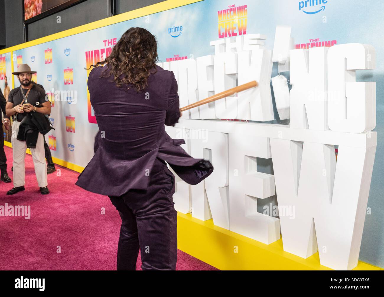 Jason Momoa wrecks with baseball bat propped sign of the movie during ...
