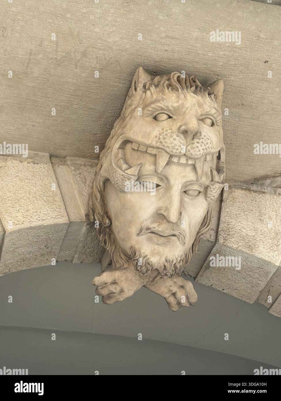 Symbolic Stone Carving Of Lion Devouring Human Face With Crossed Hands