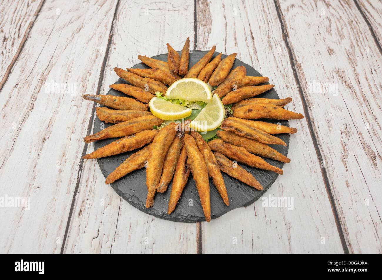 A close-up photo of a fried anchovy cut in half, showing the clean ...