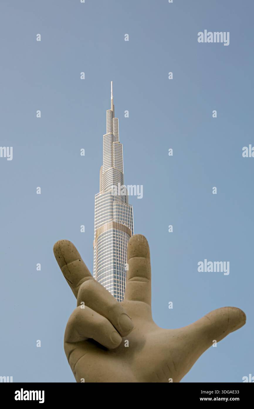 Dubai cityscape view with giant hand making love sign in foreground ...