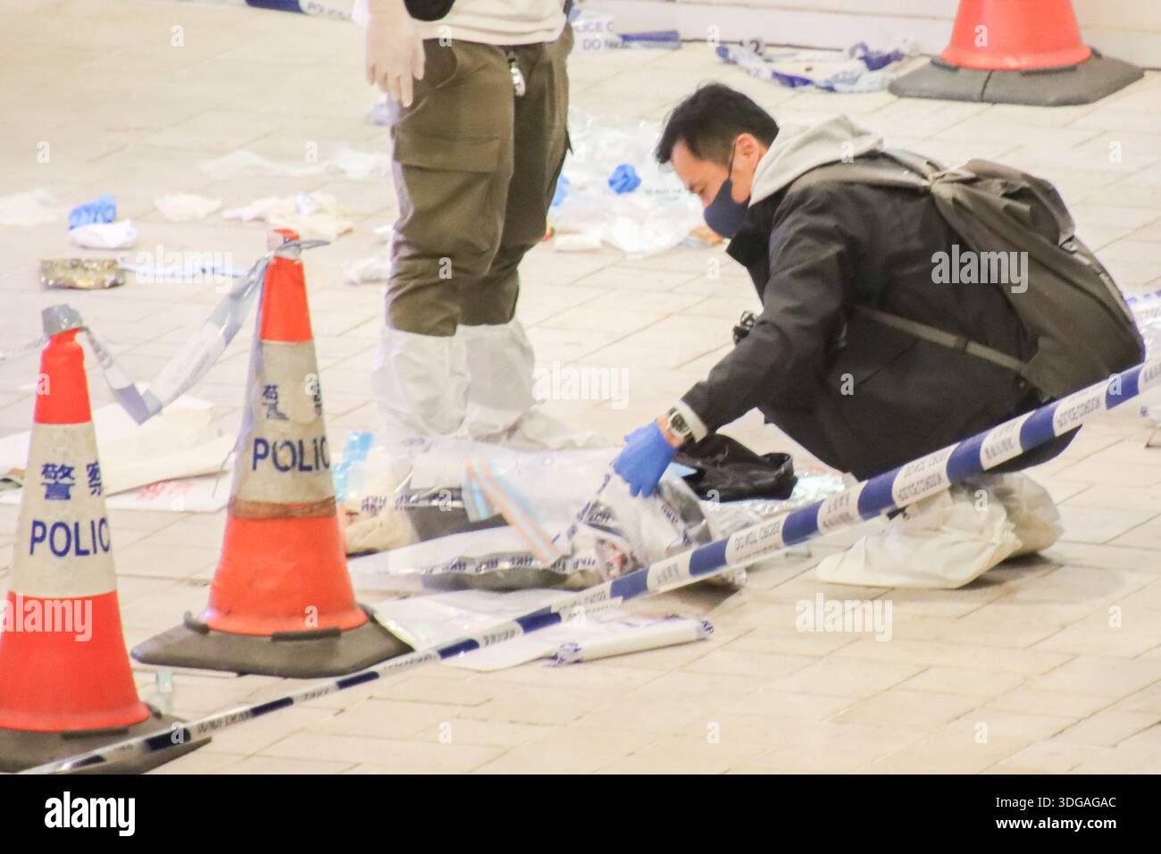 Police officers categorizing different exhibits related to the case on ...