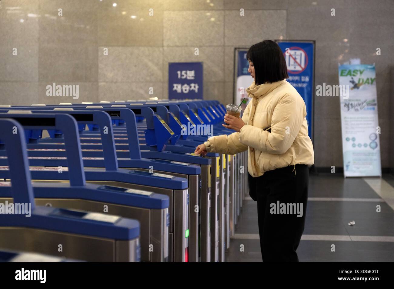 Seoul, South Korea: Female commuter tapping transit card at subway gate ...