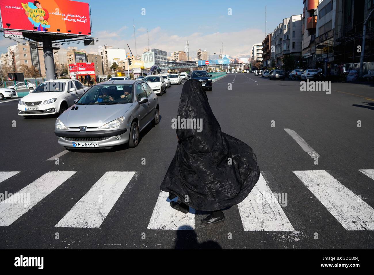 A woman crosses an intersection in downtown Tehran, Iran, Friday, Jan ...